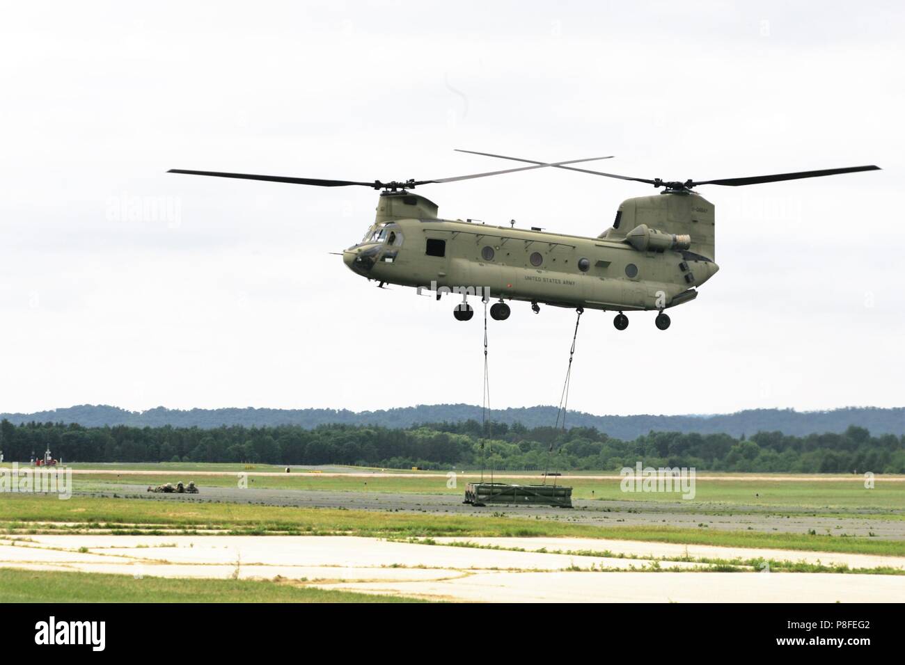 An aircrew of a Chinook helicopter picks up a mock ammunition pallet ...
