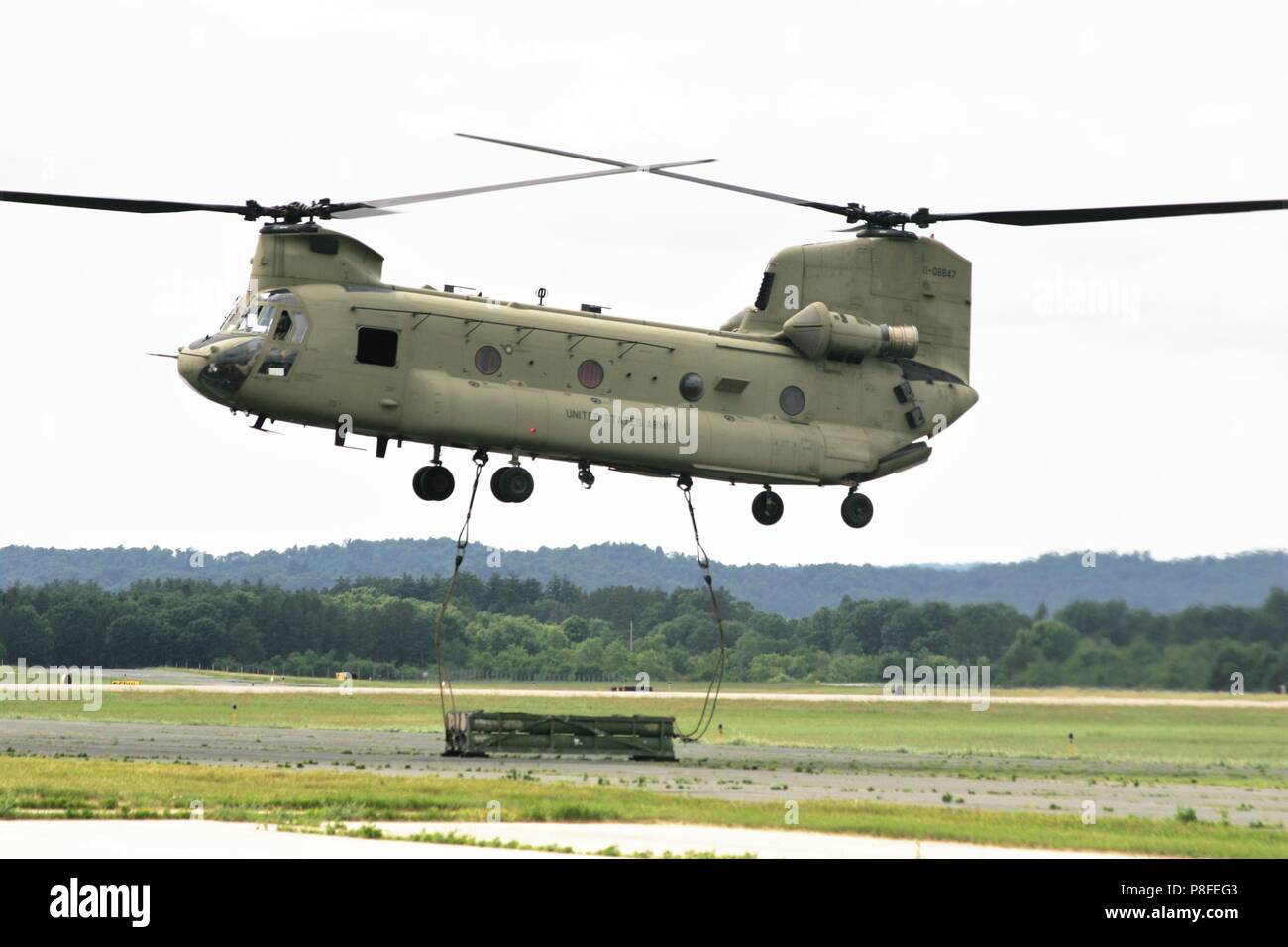 An aircrew of a Chinook helicopter picks up a mock ammunition pallet ...