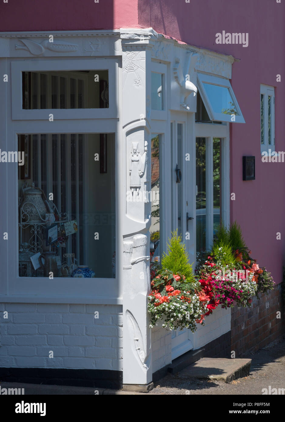 An unusual corner window with decorative carving on the corner post ...