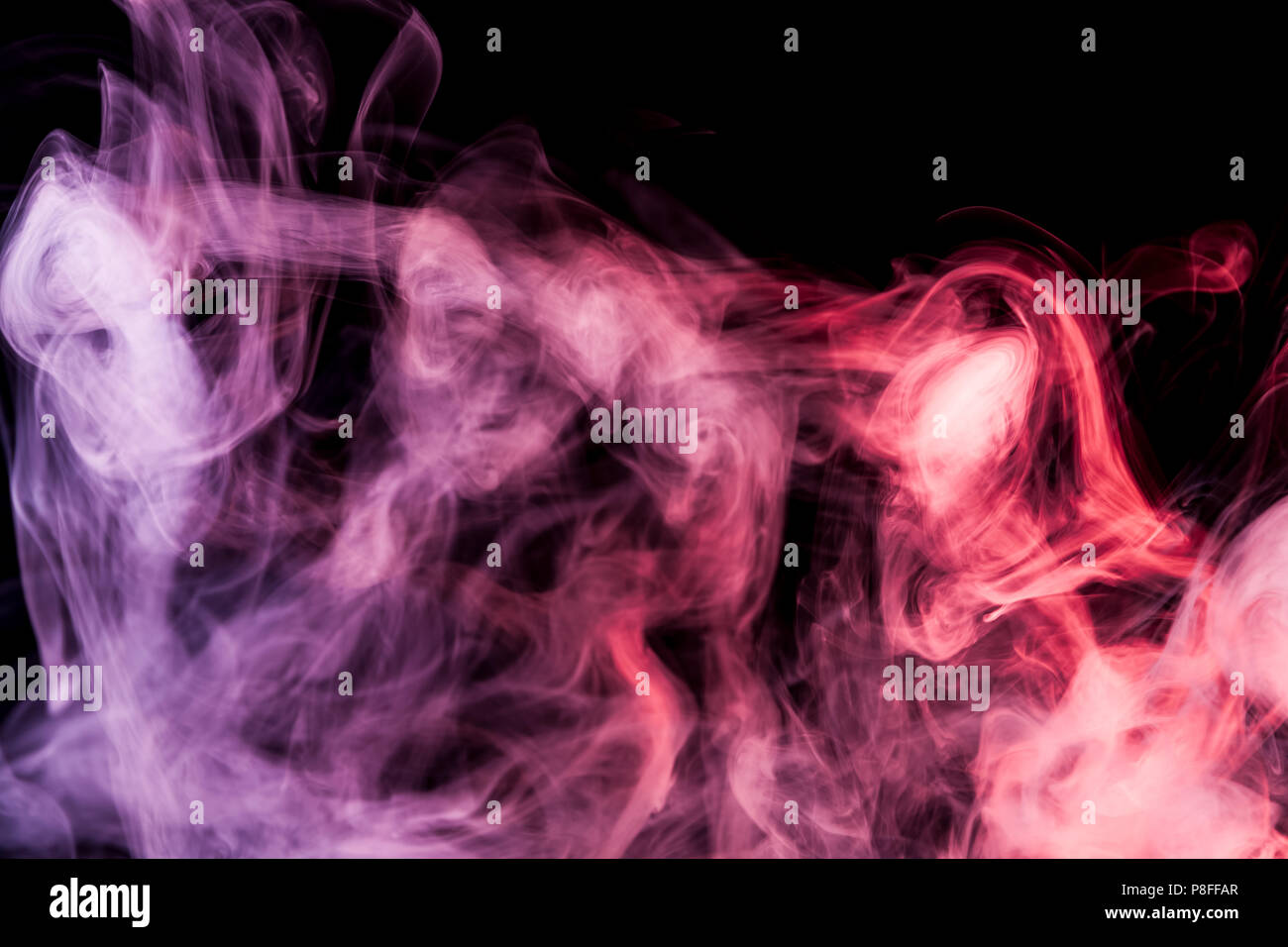 Thick colorful smoke of pink, purple, red on a black isolated ...