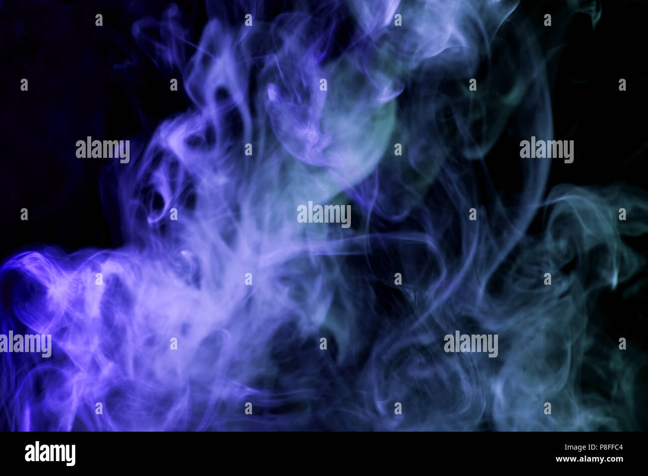 Colorful blue smoke on a black isolated background. Background from the ...