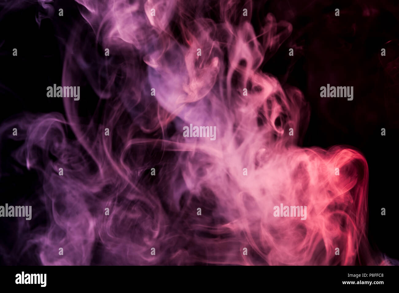 Colorful pink and red smoke on a black isolated background. Background ...