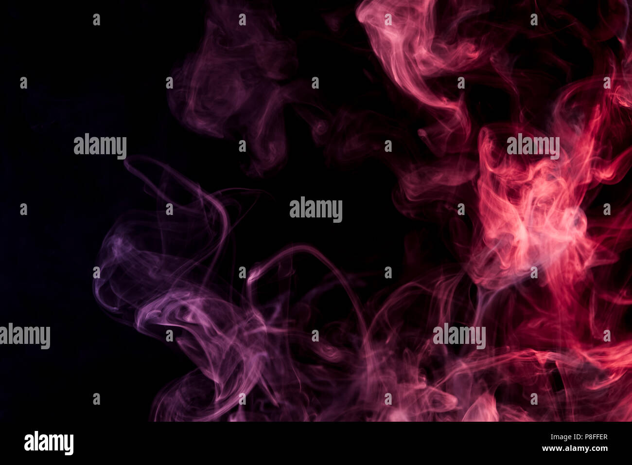 Pink, purple and red smoke on black background Stock Photo - Alamy
