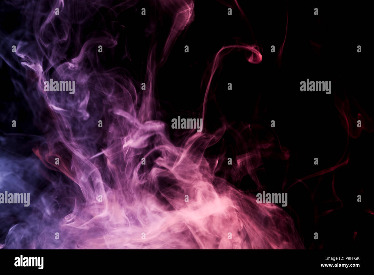 Red, purple and pink smoke on black background Stock Photo - Alamy
