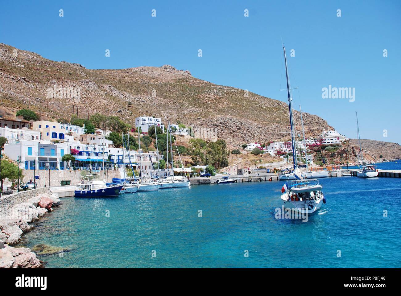 A yacht enters Livadia harbour on the Greek island of Tilos on June 12 ...