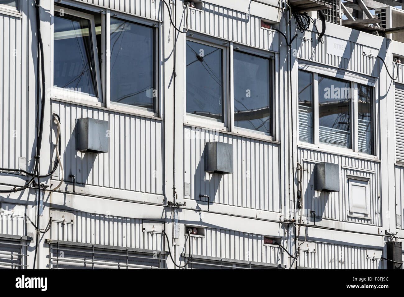 Stacked containers as construction site offices next to a large ...