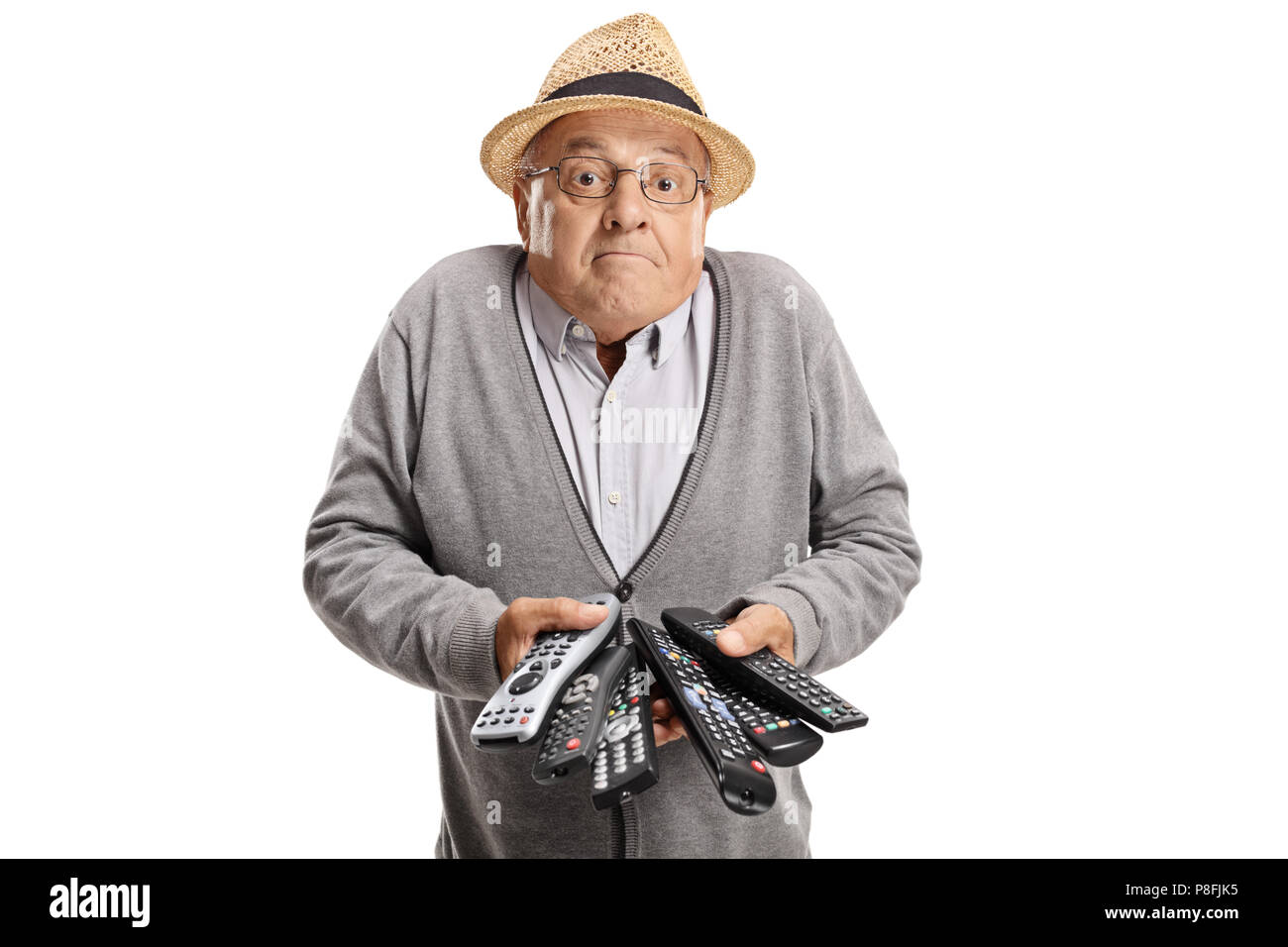 Confused elderly man with remotes isolated on white background Stock ...