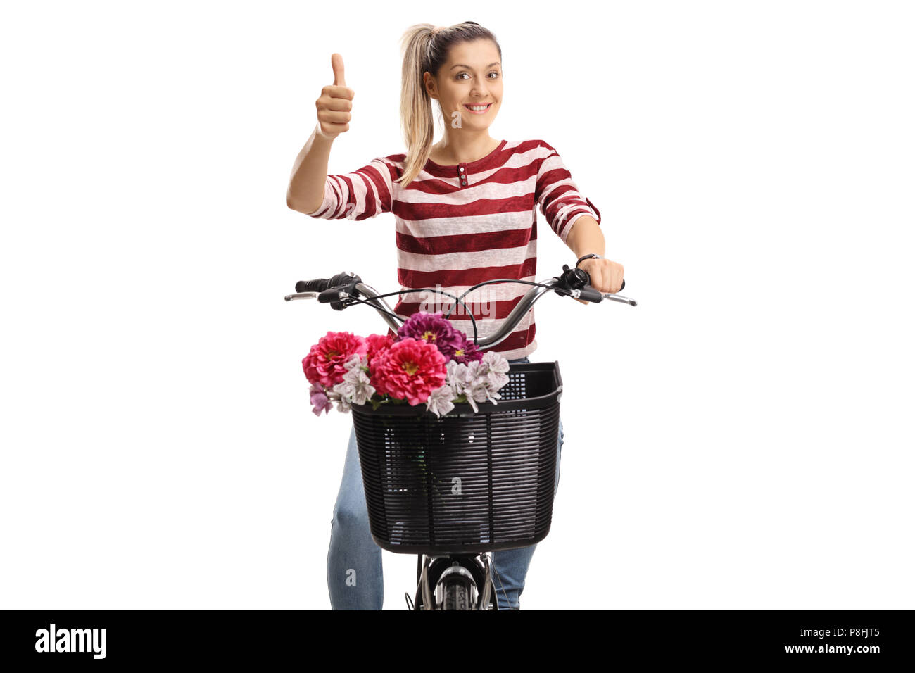 Young woman riding a bicycle and making a thumb up sign isolated on ...