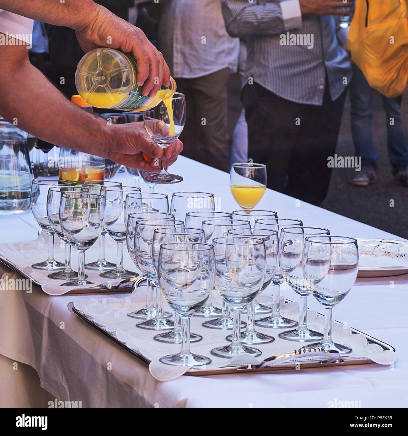 The barman pours a drink in a glass on a buffet table Stock Photo - Alamy