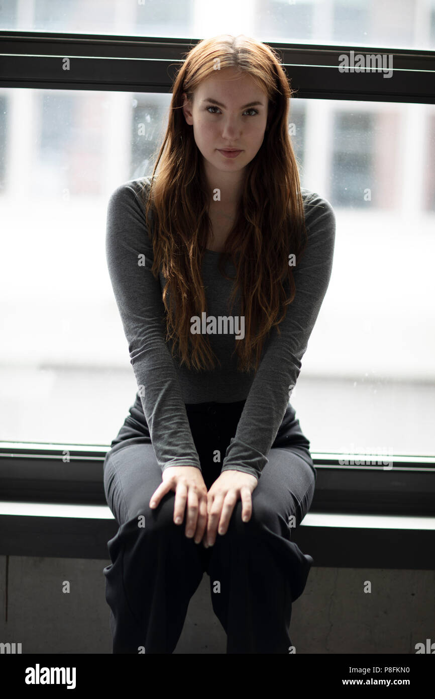 Woman sitting on ledge window hi-res stock photography and images - Alamy