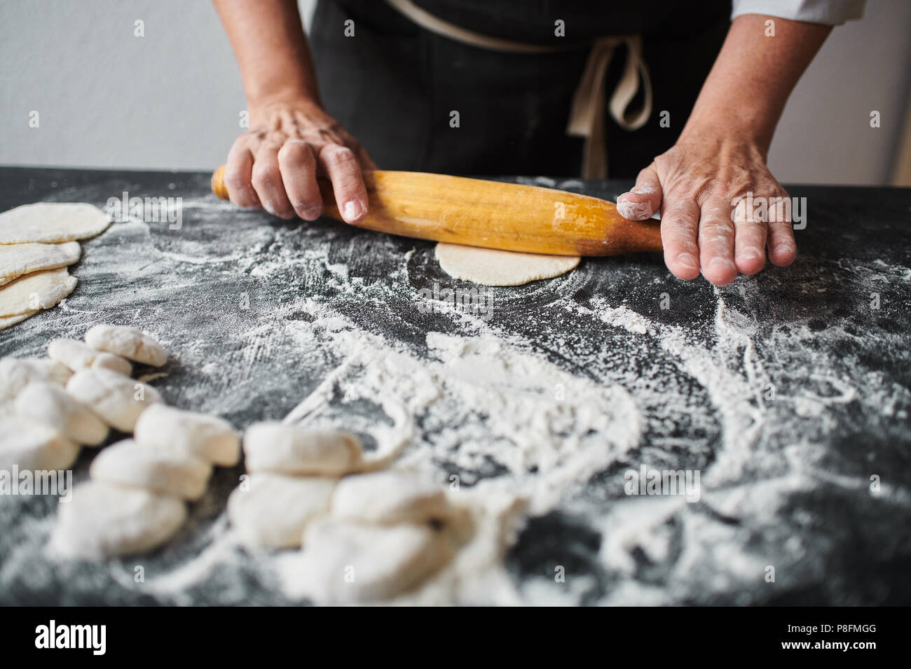 Rolling dough hands wooden roller hi-res stock photography and images ...