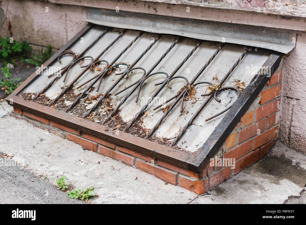 barred grate covered basement window Stock Photo - Alamy
