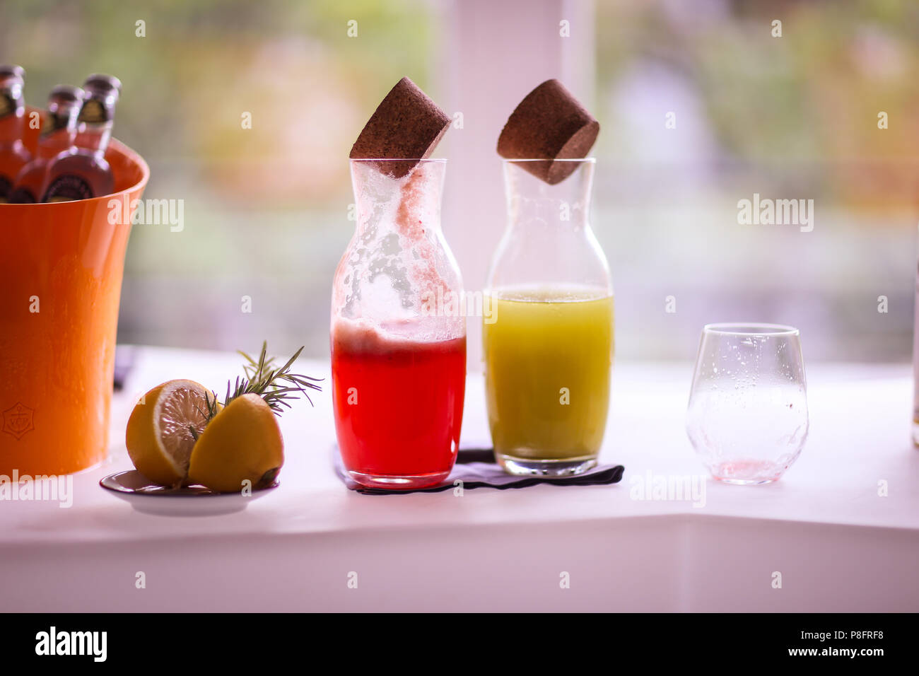 Two bottles with lemonade (mint and forest fruits), an empty dirty ...
