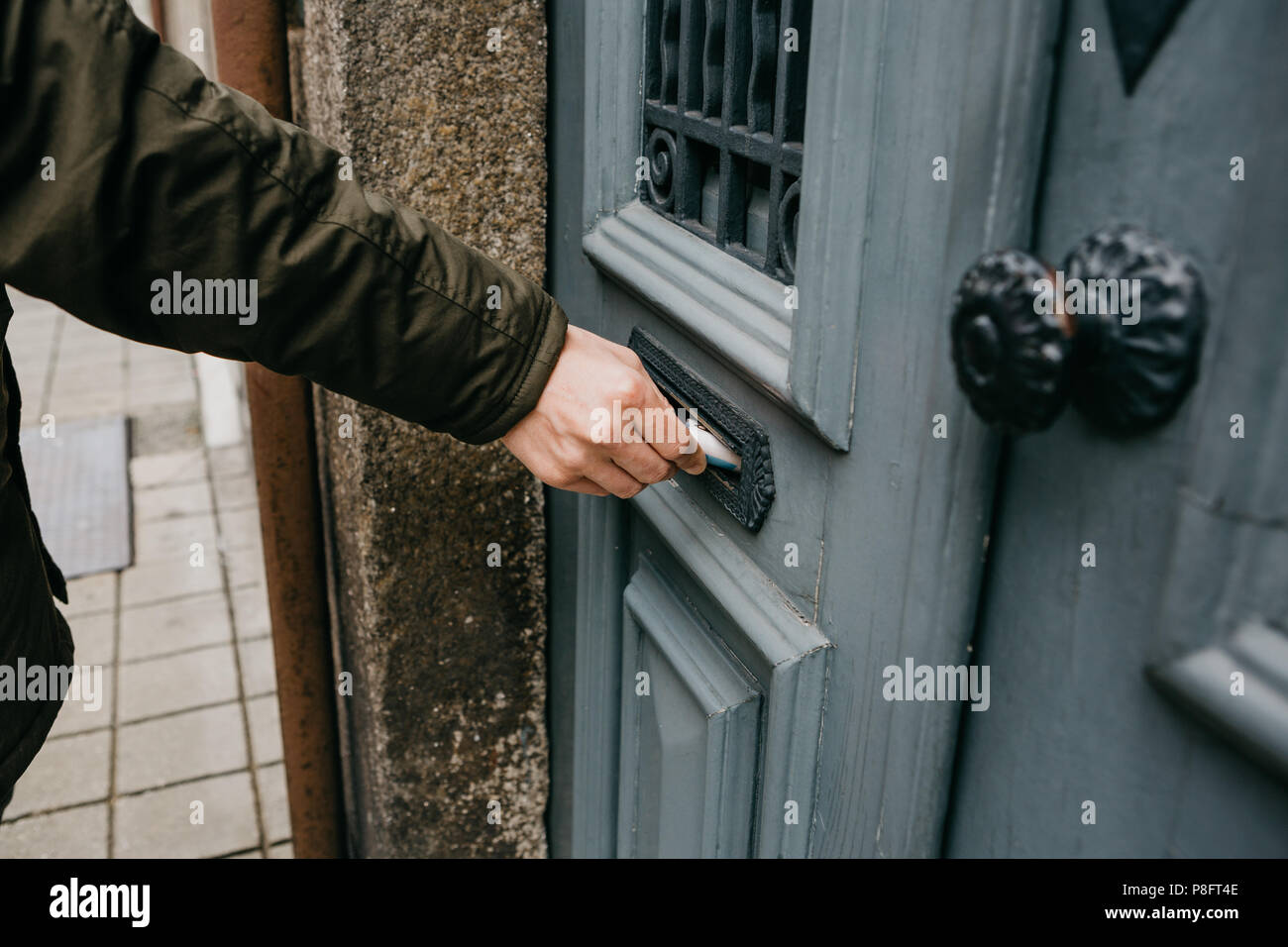 The postman puts a letter or newspaper or magazine in the mailbox at ...