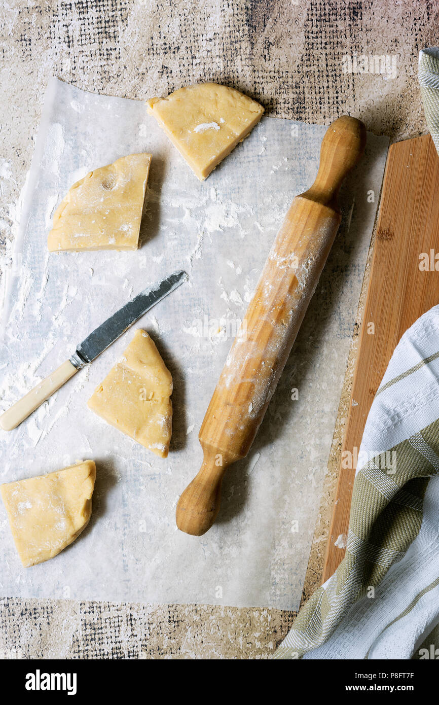 Pieces of homemade shortcrust pastry with a knife and rolling pin on ...