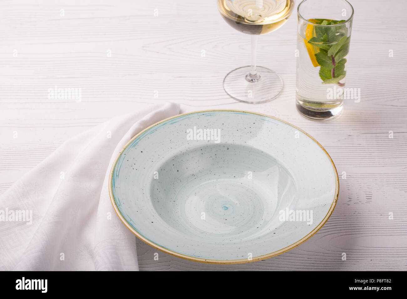 An ice lemon soda, an empty plate waiting for food in the restaurant, a ...