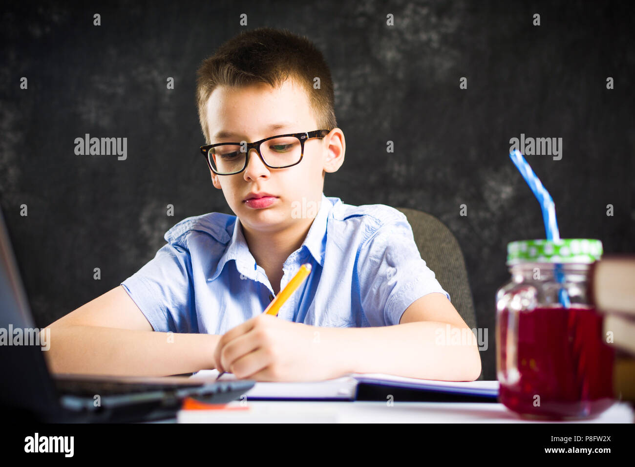 Schoolboy working desk hi-res stock photography and images - Alamy