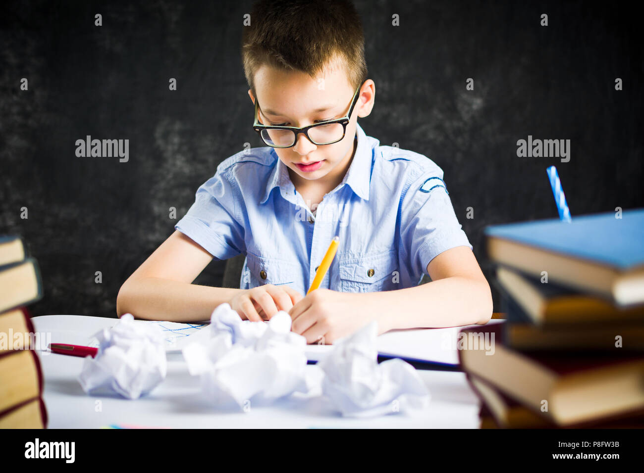 Schoolboy studying and working on homework at home Stock Photo - Alamy