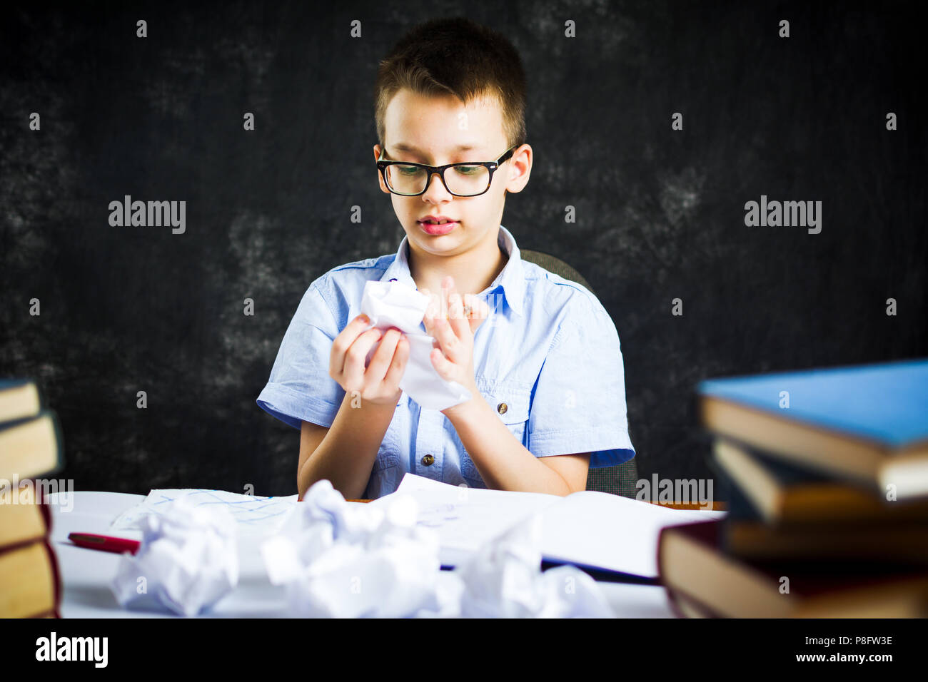 Schoolboy throwing out failed homework solutions at home Stock Photo ...