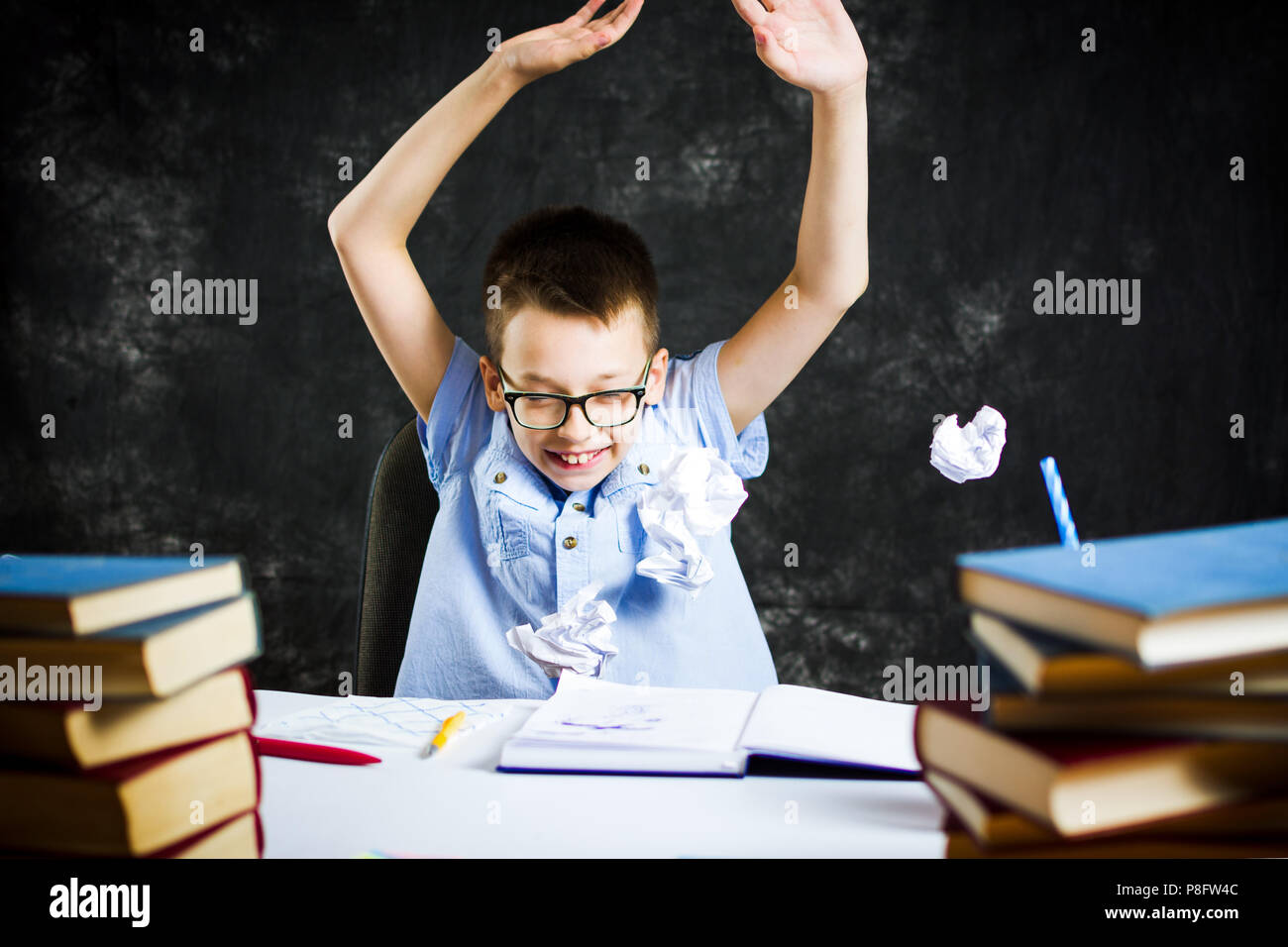 Schoolboy throwing out failed homework solutions at home Stock Photo ...