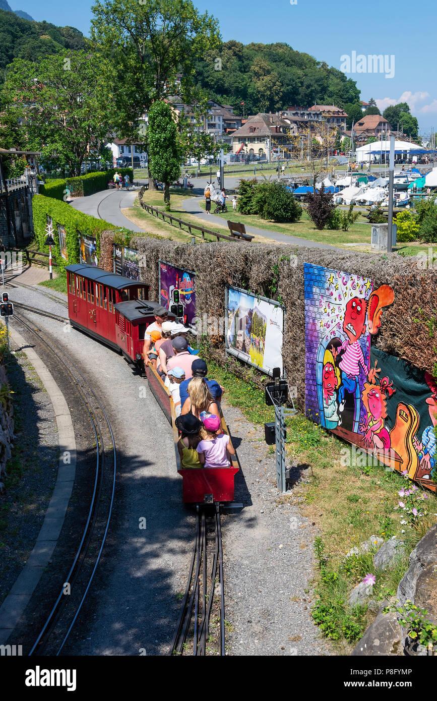 A Miniature Electric Passenger Engine and Train on Track at the Swiss ...