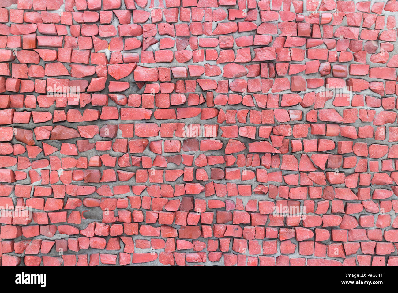 Pink smalt pebbles on gray cement wall Stock Photo - Alamy