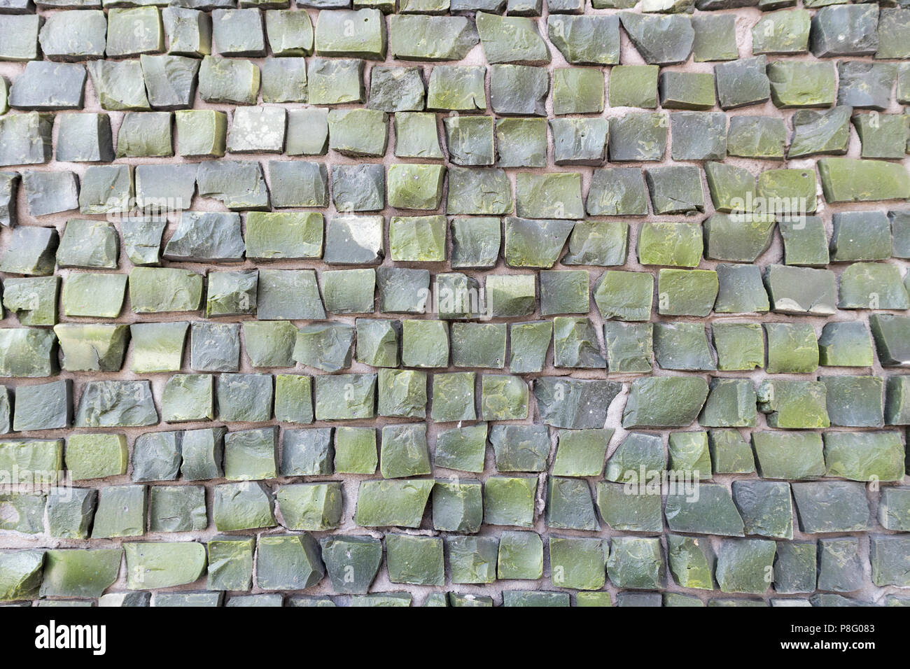 Green (olive) smalt on gray cement Stock Photo - Alamy