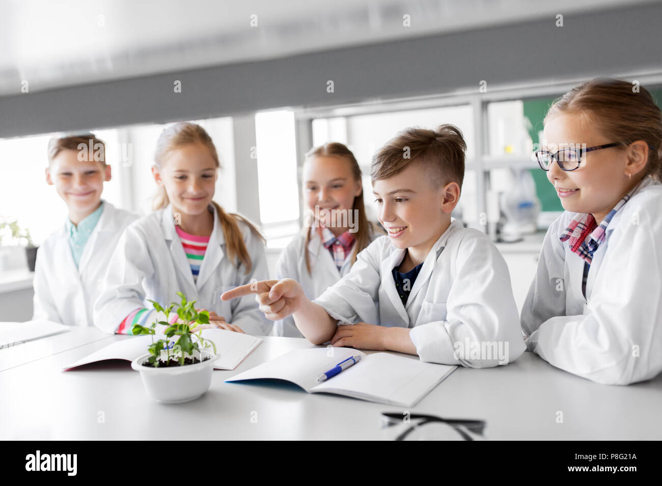 kids or students with plant at biology class Stock Photo - Alamy