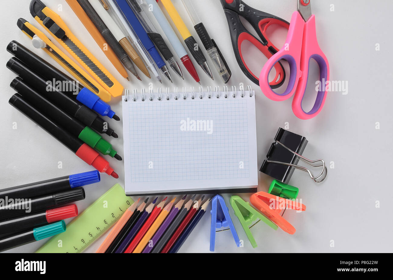 opened Notepad and office supplies on white background.photo with copy ...