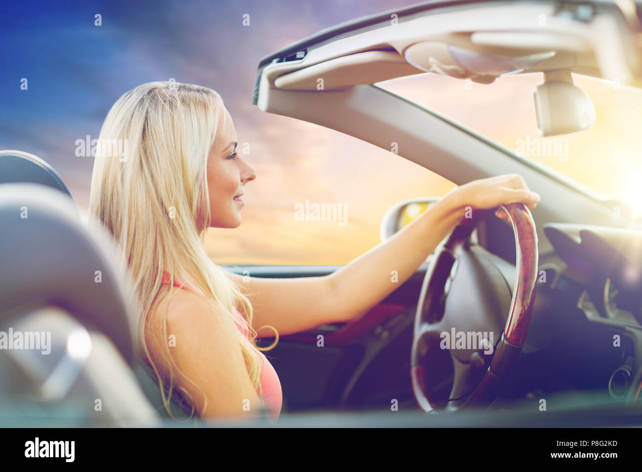 happy young woman driving convertible car Stock Photo - Alamy