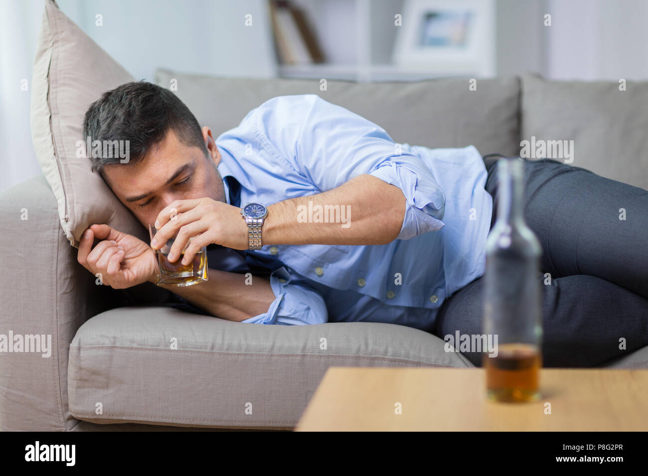 Alcoholic man sofa addiction hi-res stock photography and images - Alamy