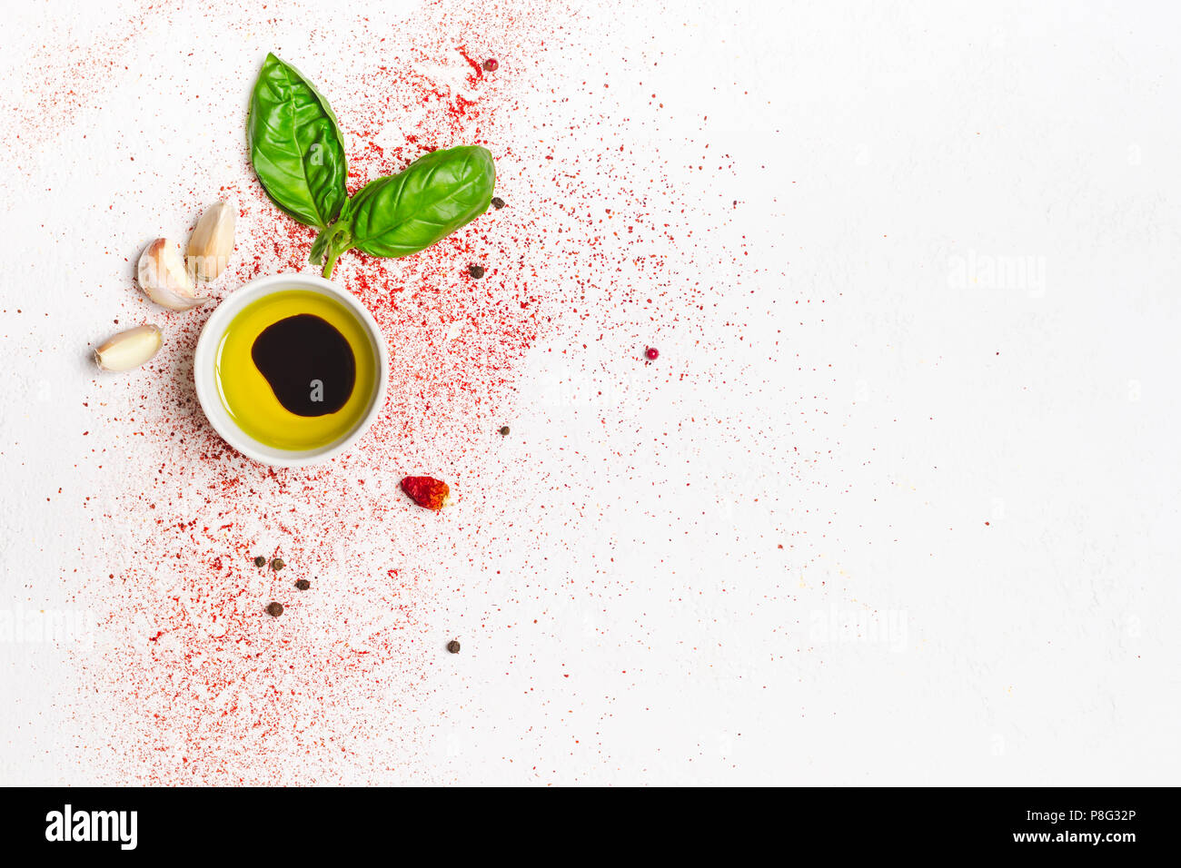 Olive oil and sprig of basil on a white background Stock Photo - Alamy