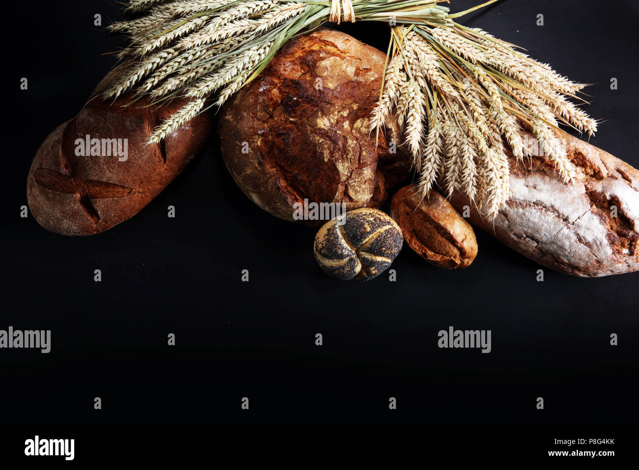 Different kinds of bread and bread rolls on board from above. Kitchen ...