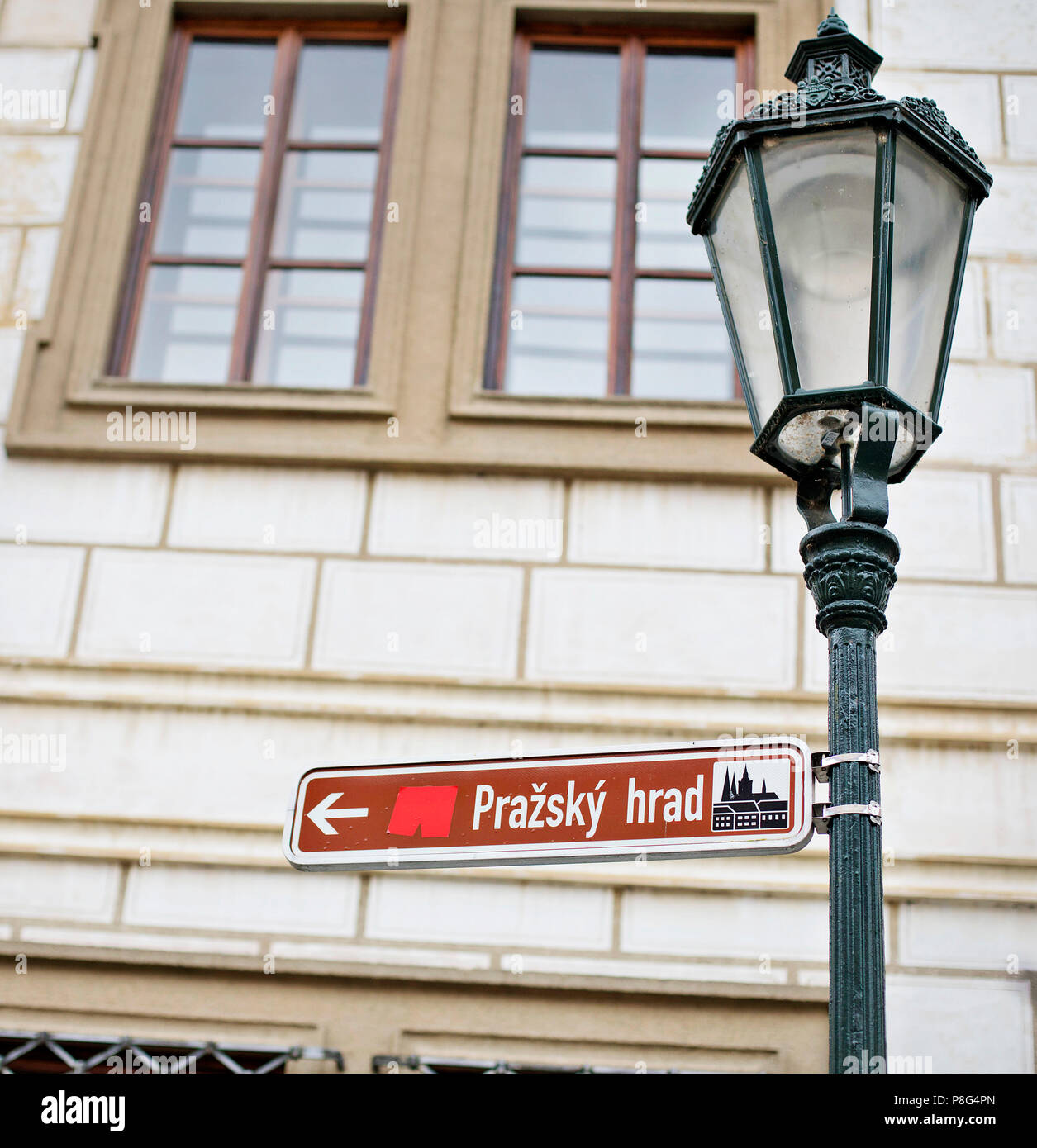The Prague Castle sign with a red trunks sticker on street lamp post ...