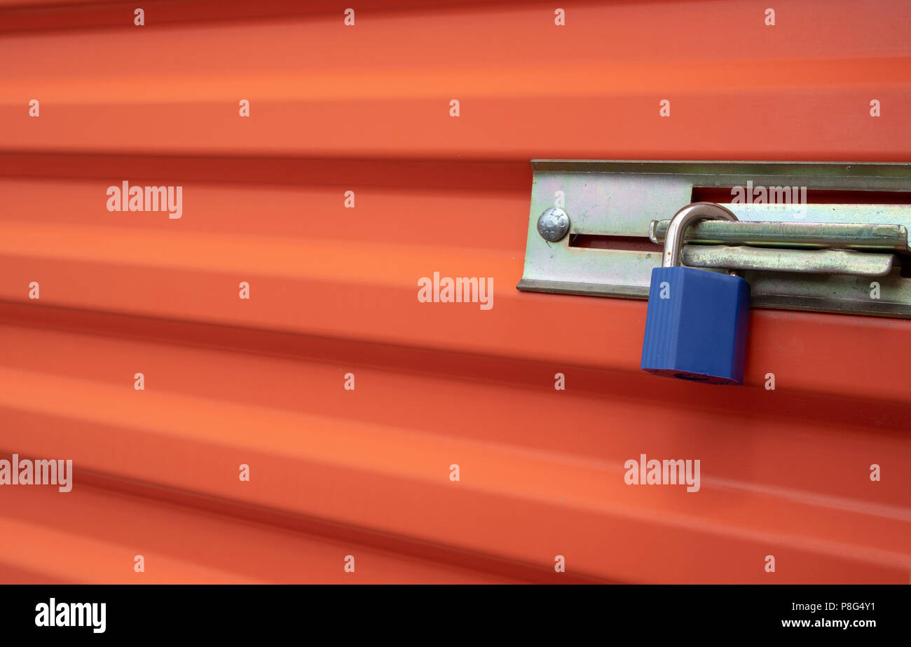 Blue plastic lock on an orange self storage unit door Stock Photo - Alamy