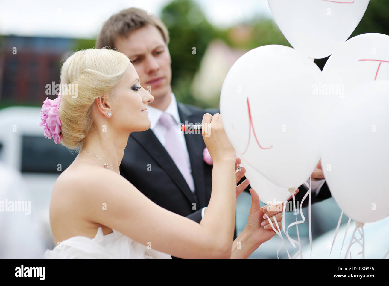 Bride and groom writing on a balloon Stock Photo - Alamy