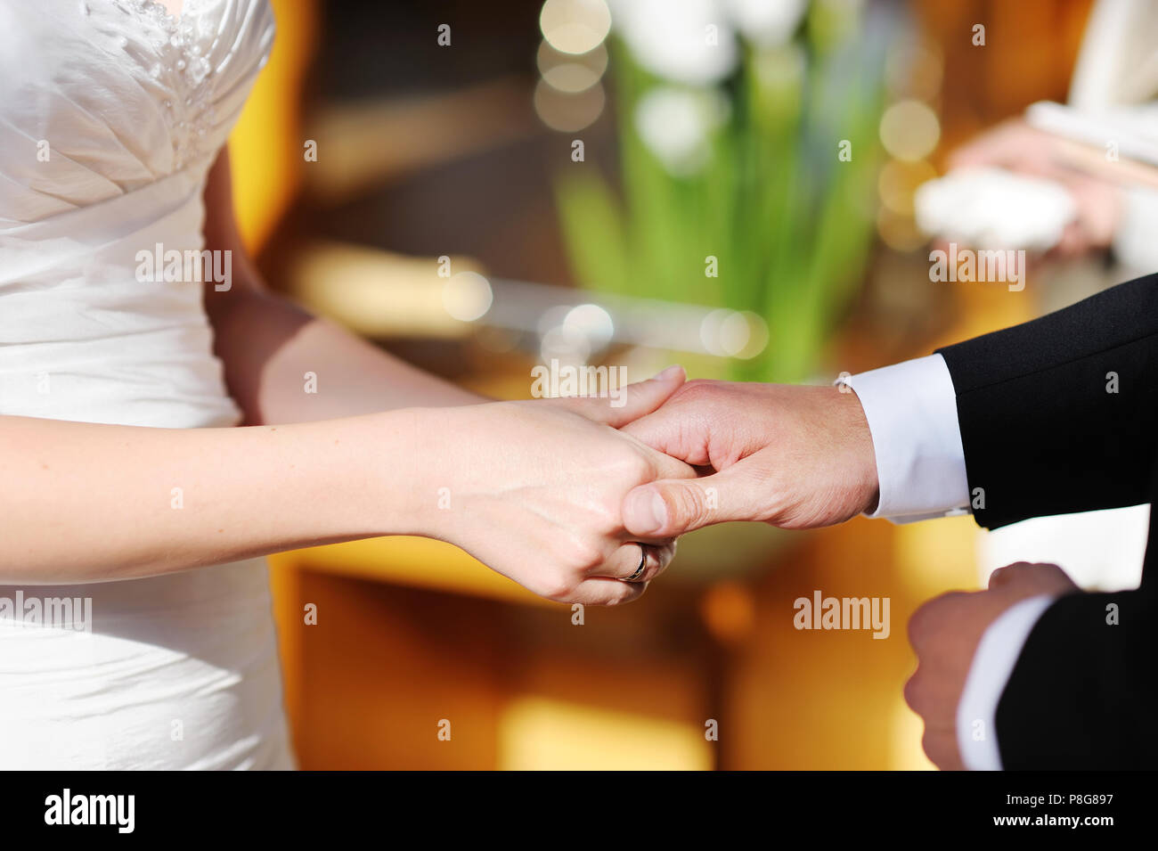 Bride and groom holding hands at the wedding ceremony Stock Photo - Alamy