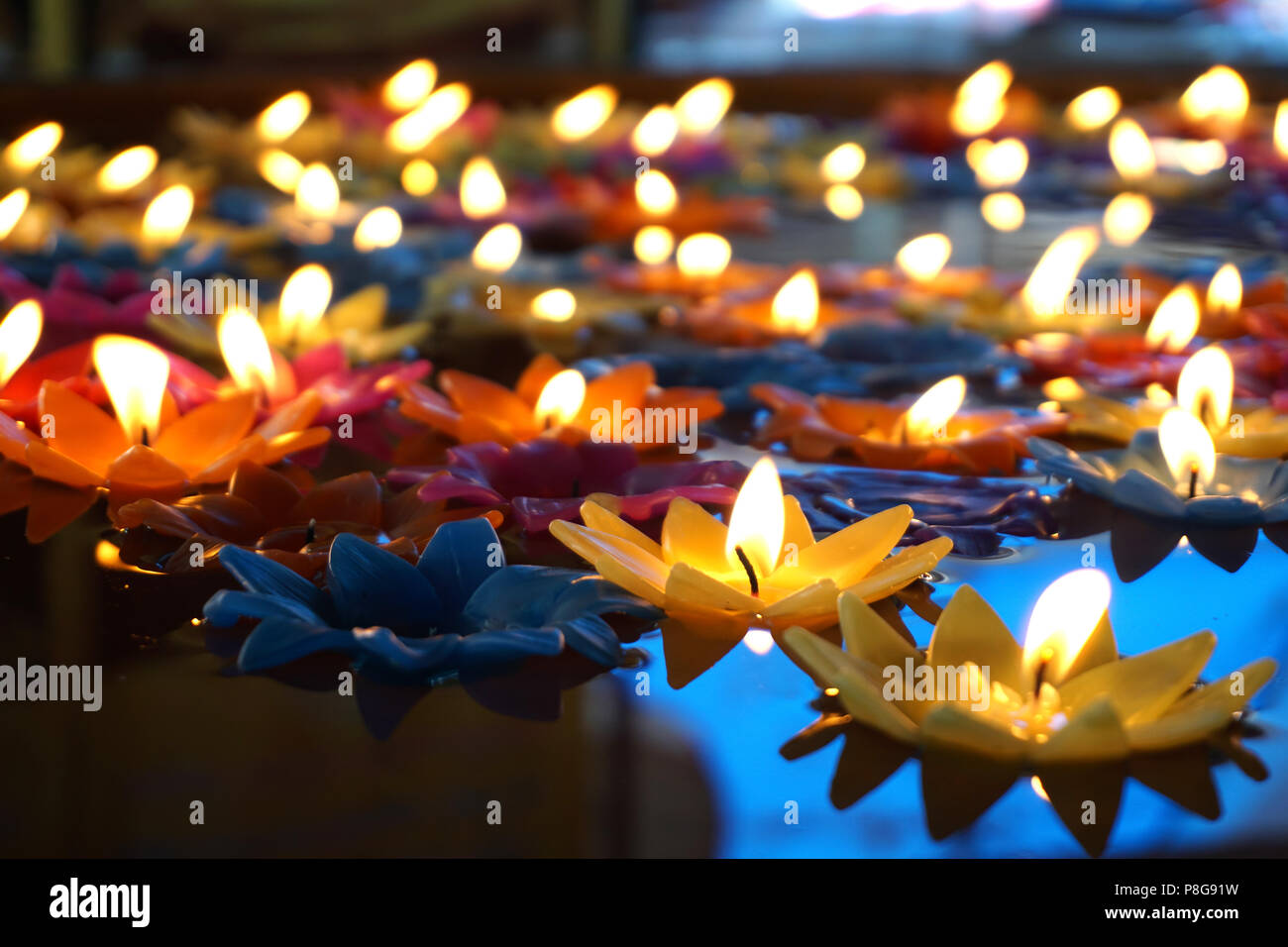 Many of colourful Floating candles Stock Photo - Alamy