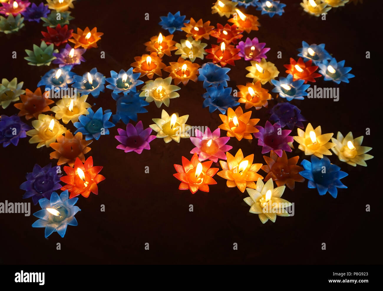 Many of colourful Floating candles Stock Photo - Alamy