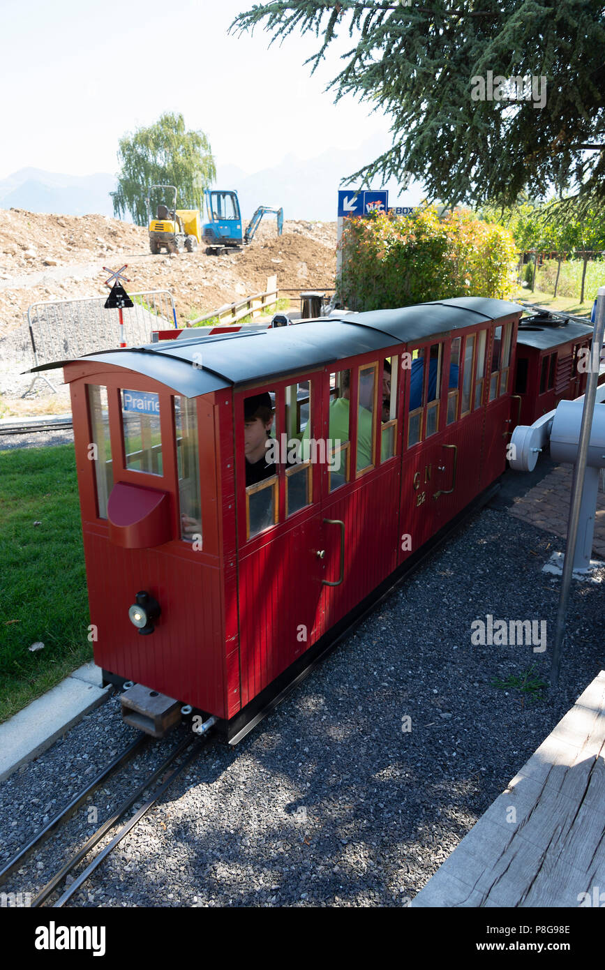 A Miniature Electric Passenger Engine and Train on Track at the Swiss ...