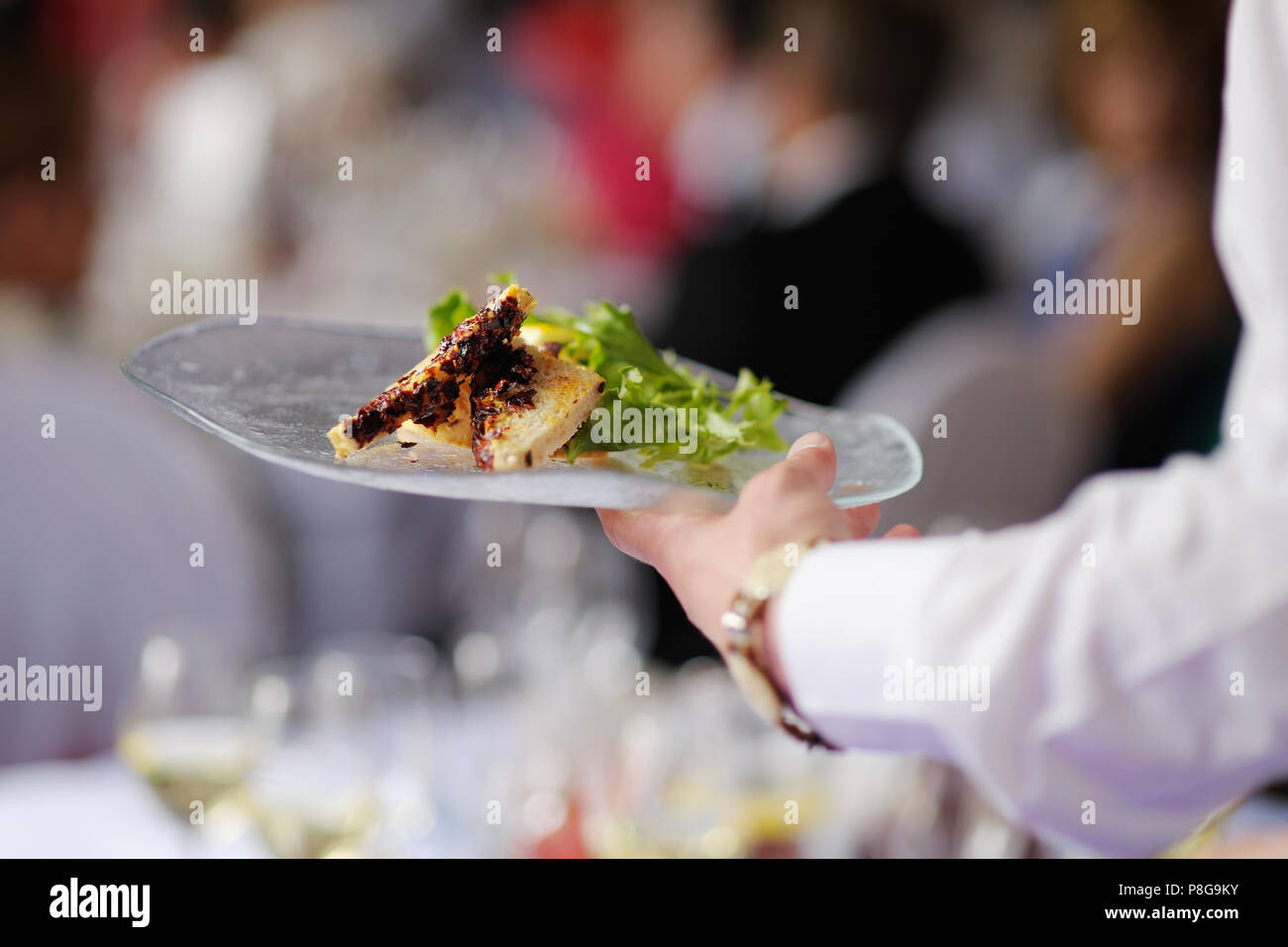 Waiter carrying plate meat dish hi-res stock photography and images - Alamy