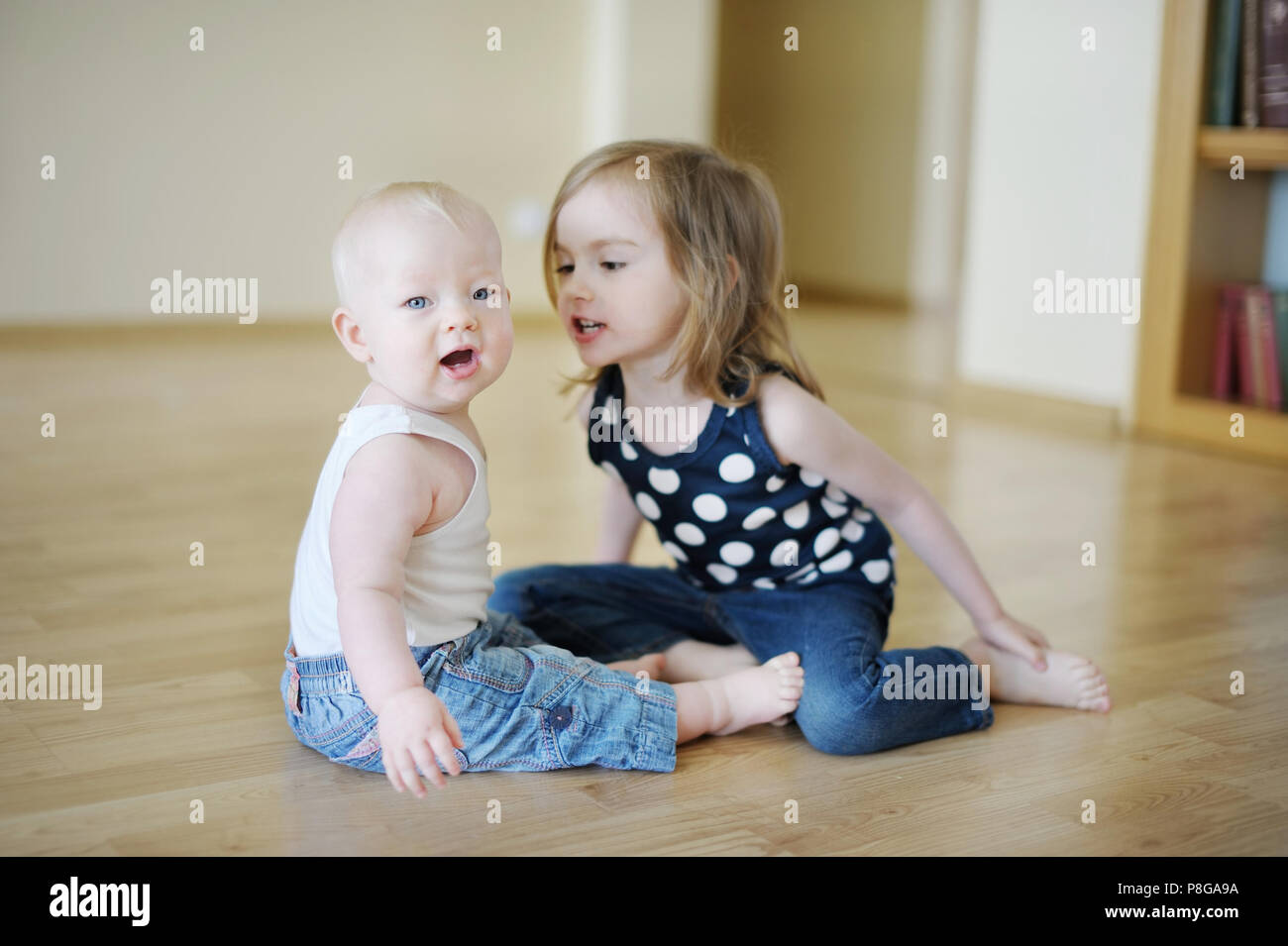 Two little sisters playing together Stock Photo - Alamy