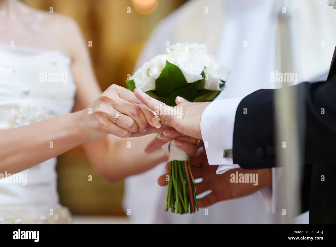 Putting wedding ring on finger during wedding ceremony hi-res stock ...
