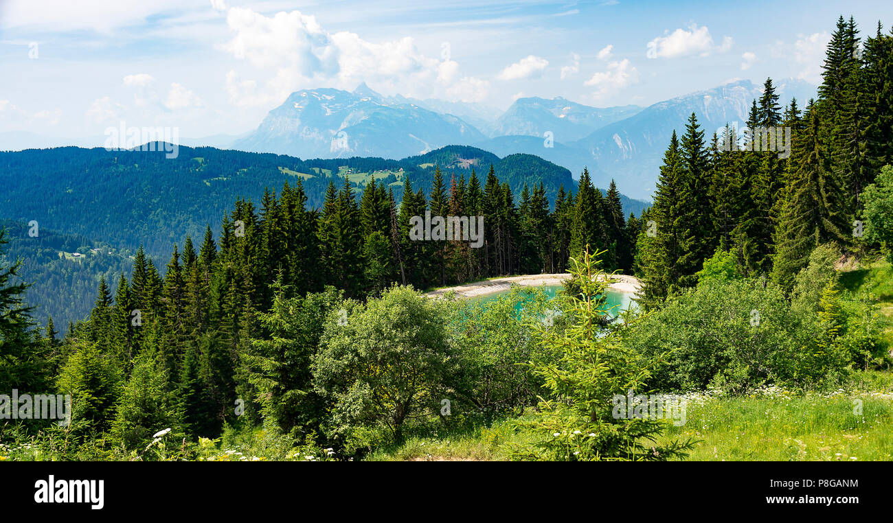 A Landscape of The Distant French Alps with a Small Green Watered Lake ...