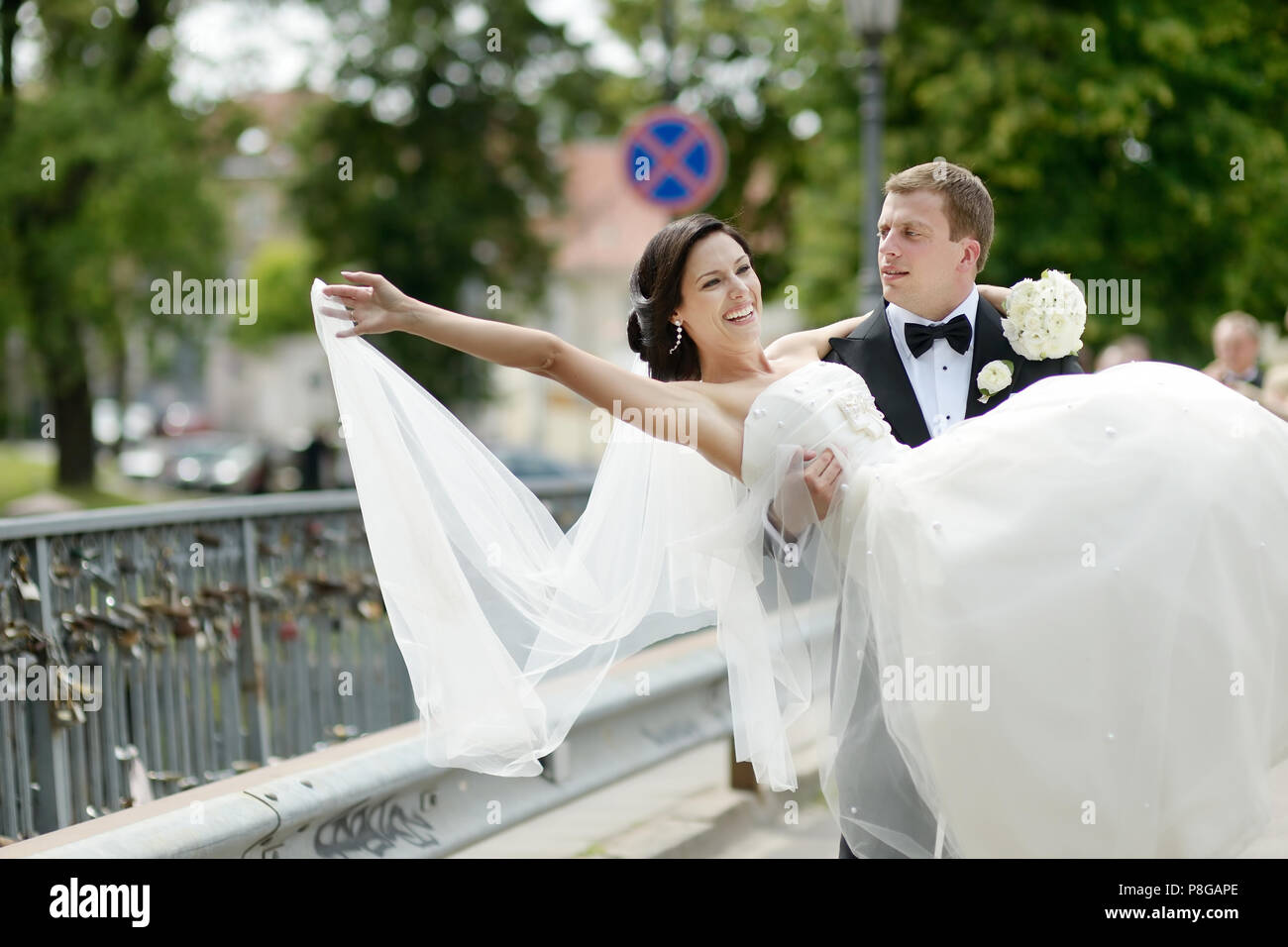 Groom carrying his beautiful bride Stock Photo - Alamy