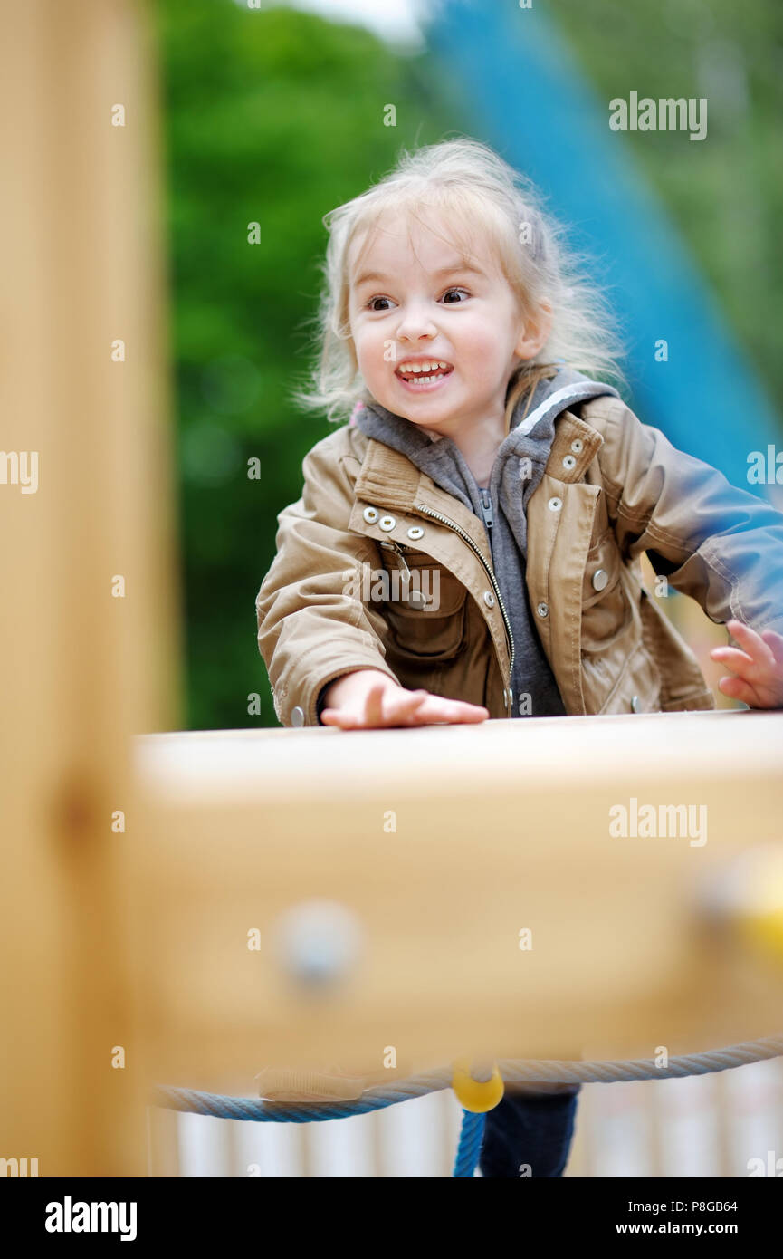 Adorable little girl having fun on a playground Stock Photo - Alamy