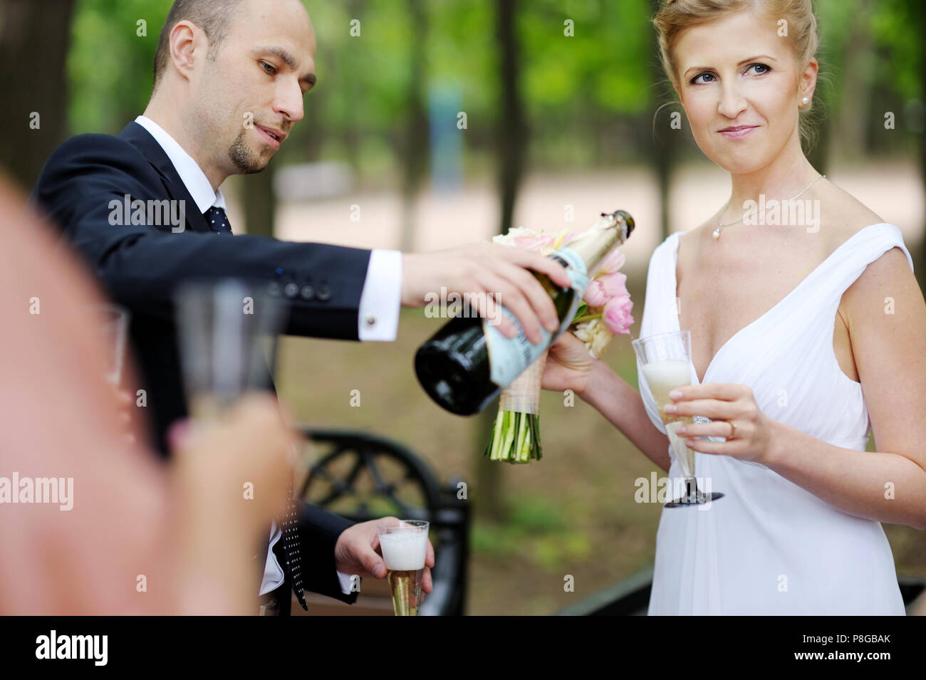 Wedding guests toasting happy bride and groom Stock Photo - Alamy