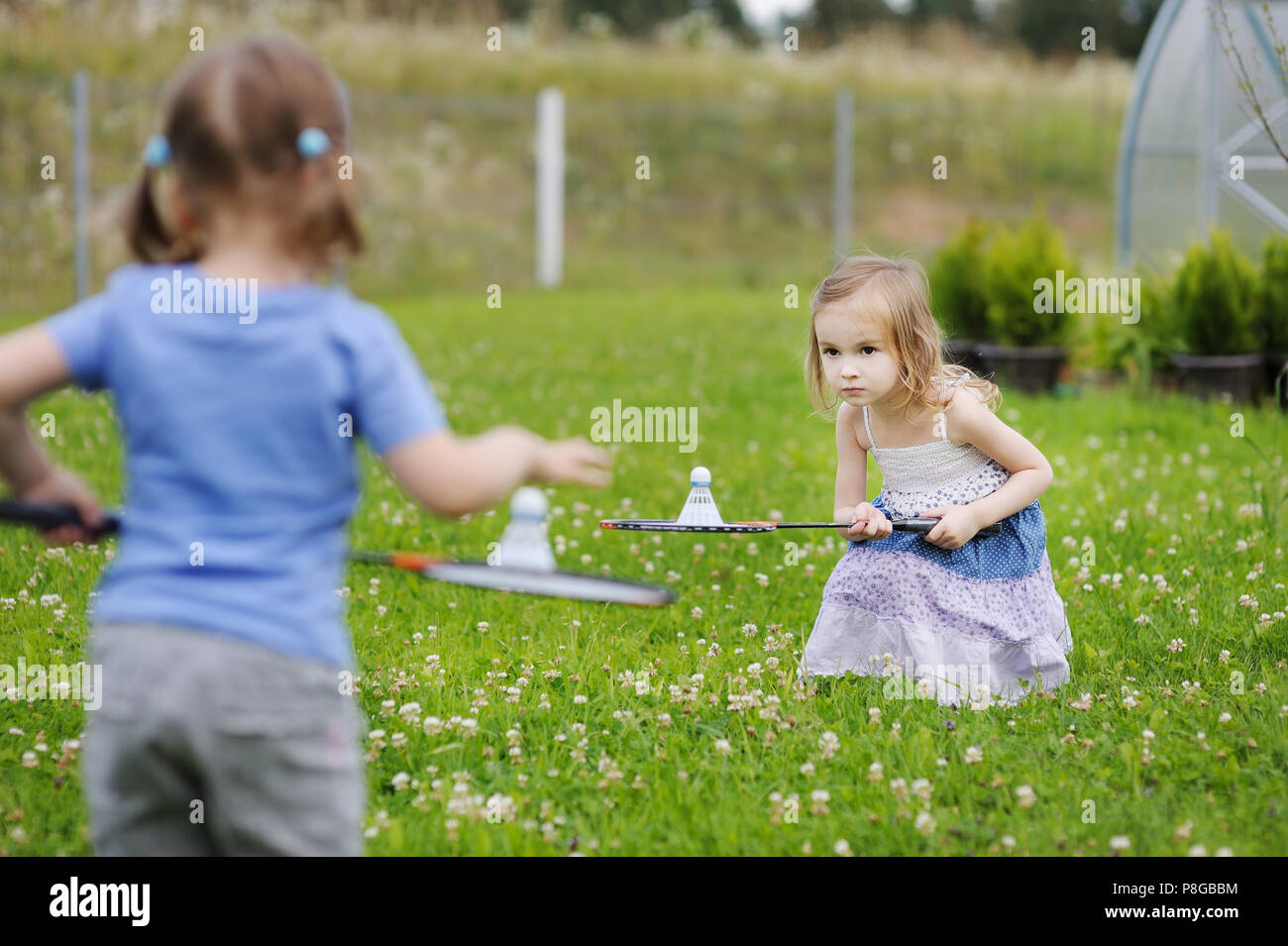 Kids playing badminton on beautiful summer day Stock Photo - Alamy