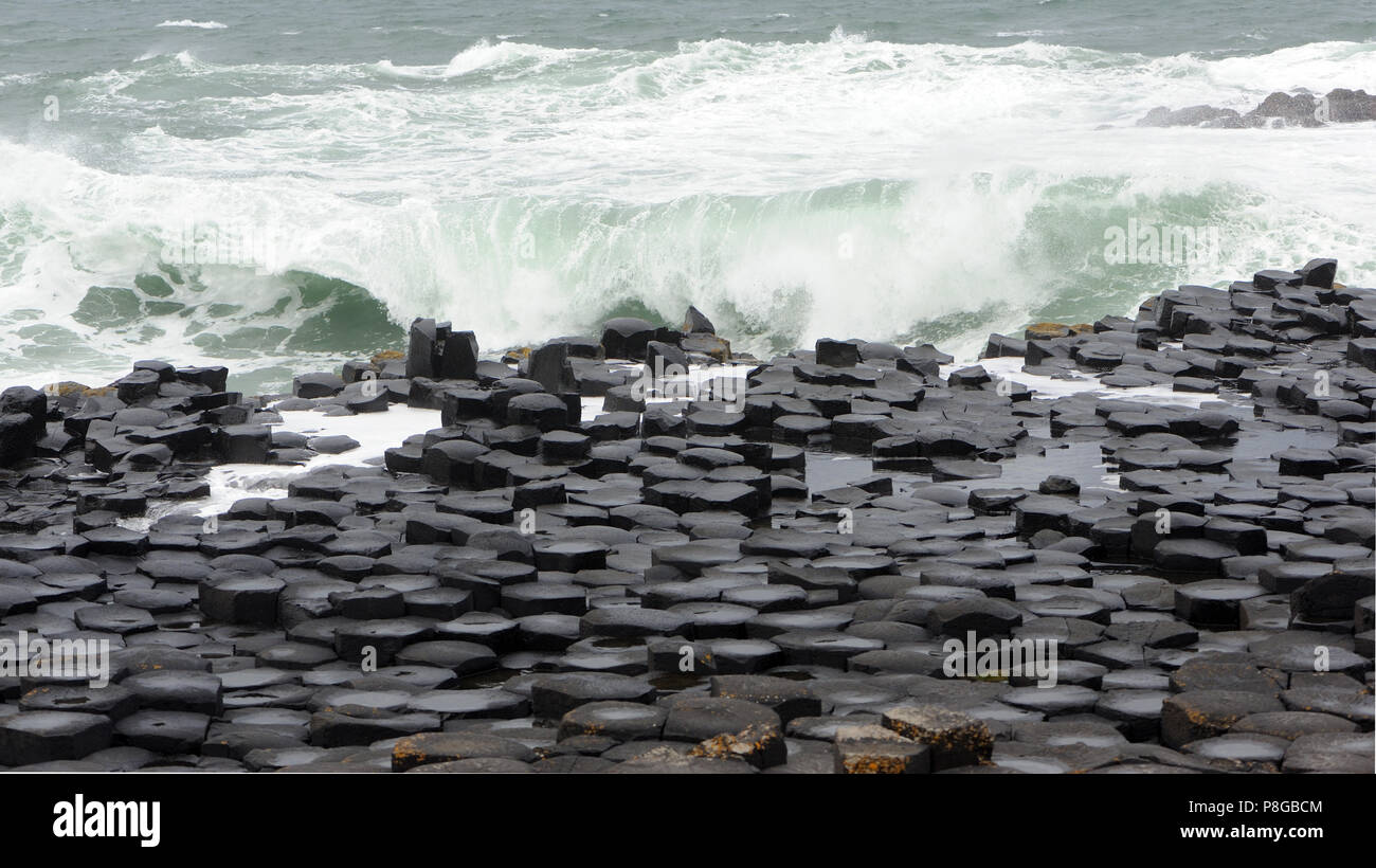 Waves break on the polygonal basalt columns of the Giant’s Causeway ...
