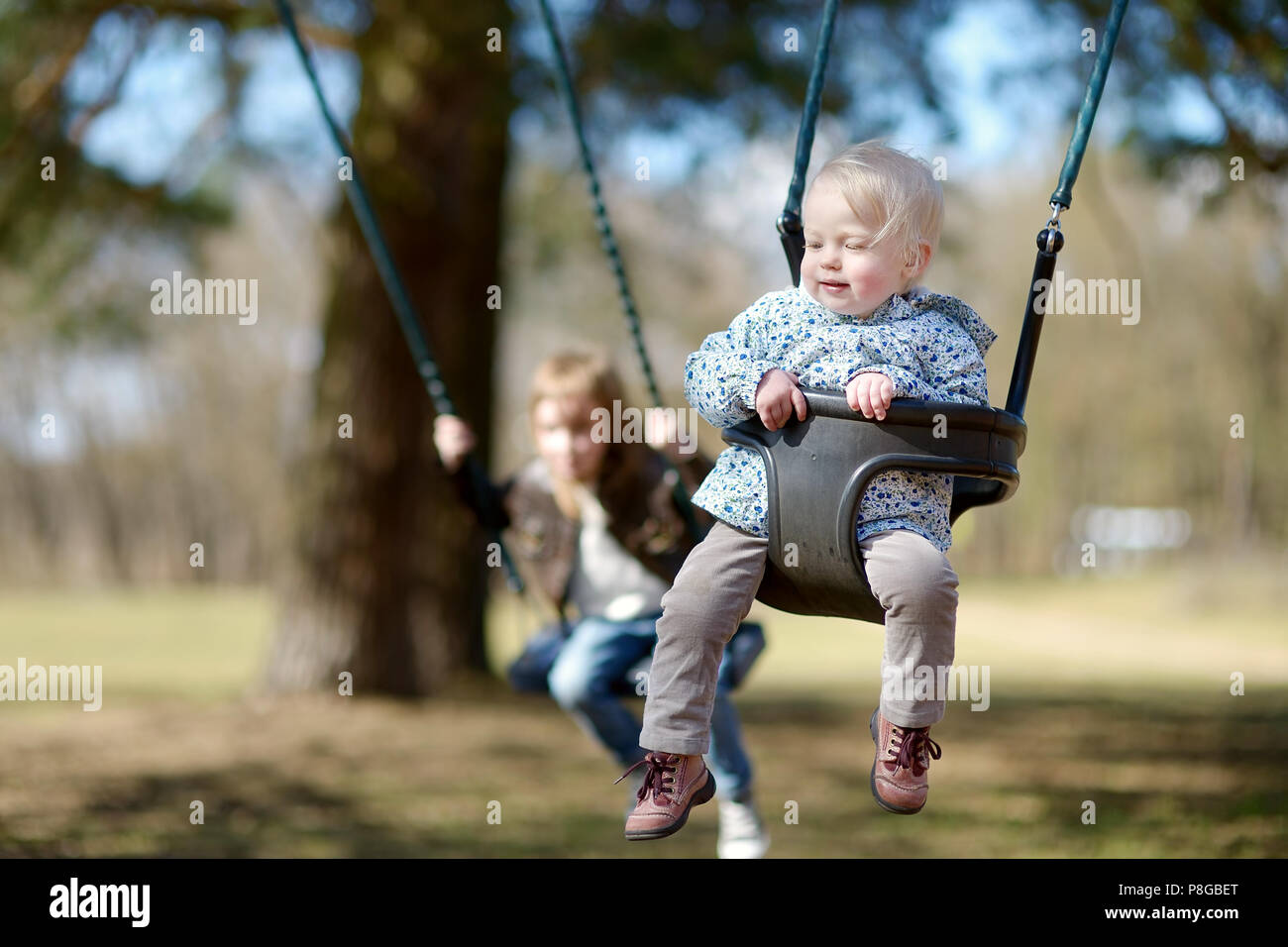 Children swinging high hi-res stock photography and images - Alamy